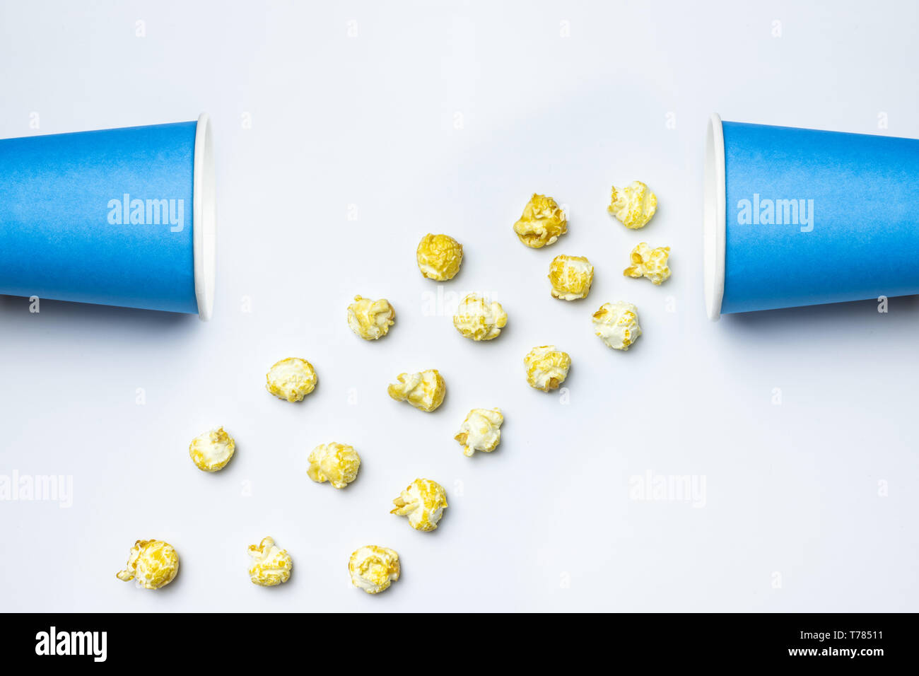 Popcorn spill concept. Isolated white background. Delicious sweet ...