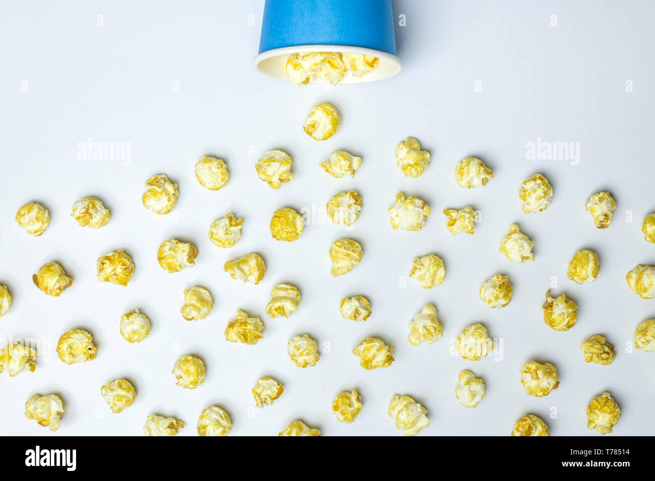 Popcorn spill concept. Isolated white background. Delicious sweet ...