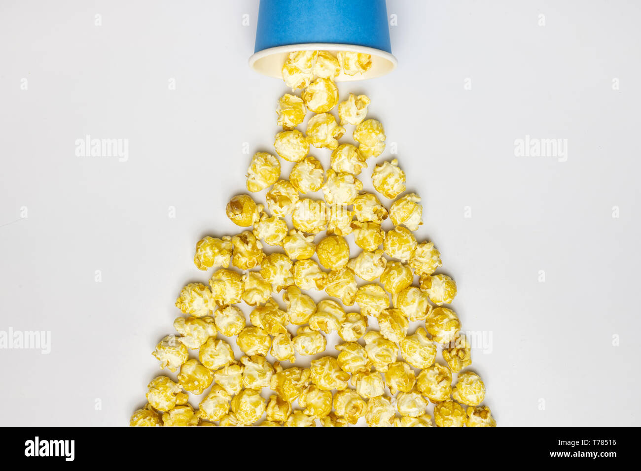 Popcorn spill concept. Isolated white background. Delicious sweet ...