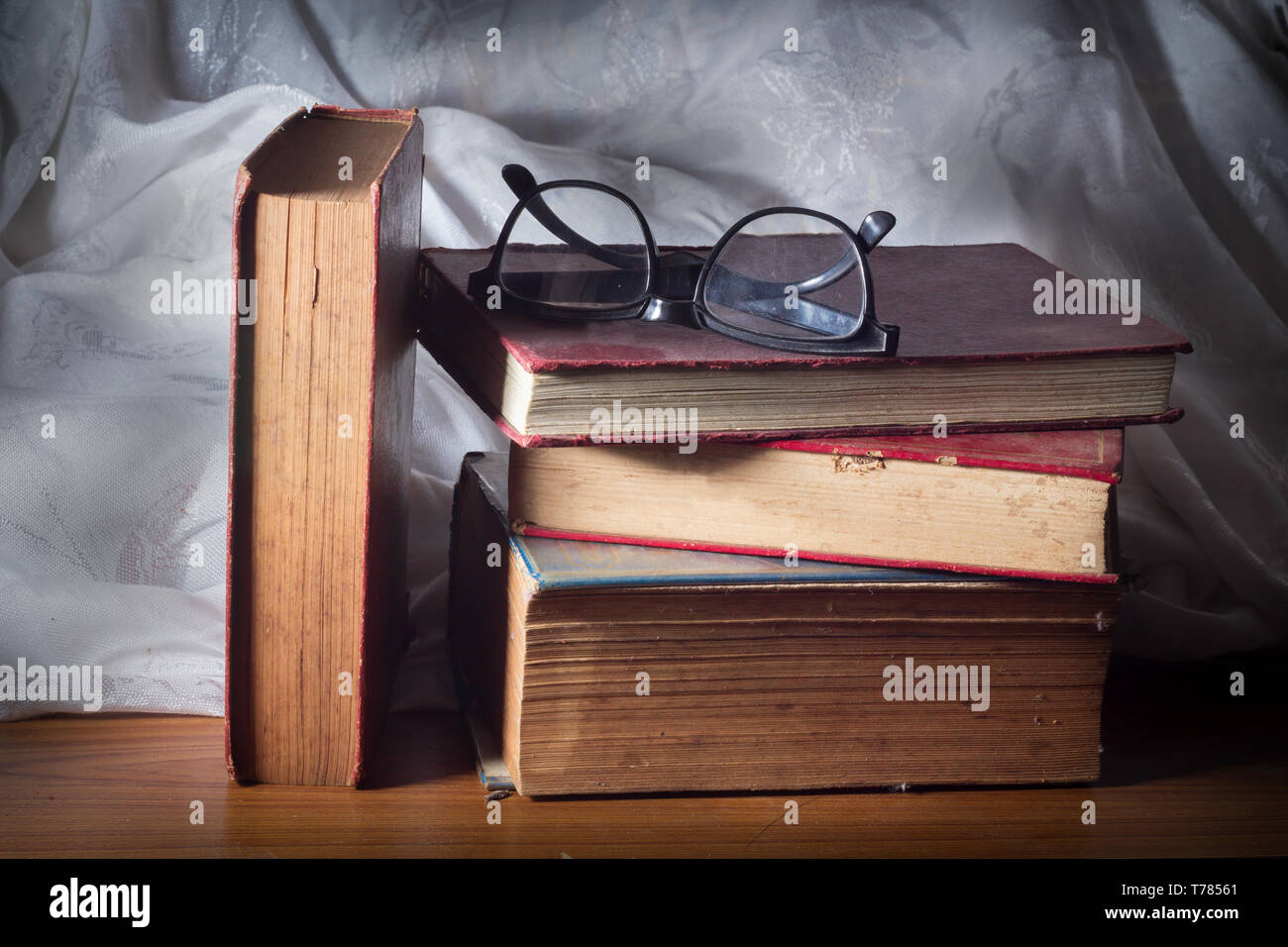 Stack books with eyeglasses,still life Stock Photo - Alamy