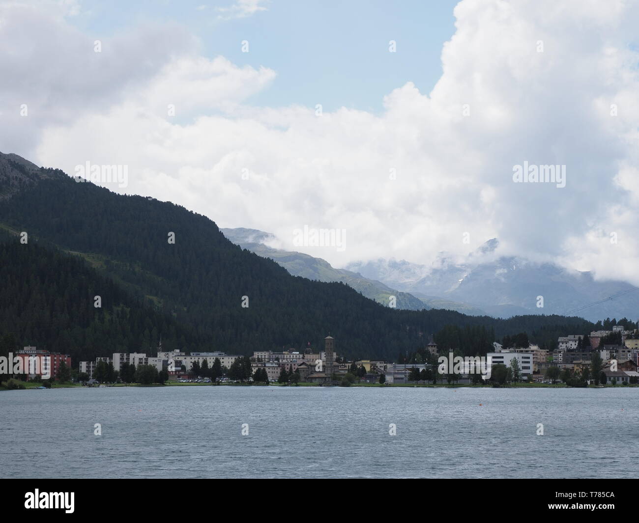 Lake St. Moritz at alpine landscape in Switzerland with cloudy blue sky ...