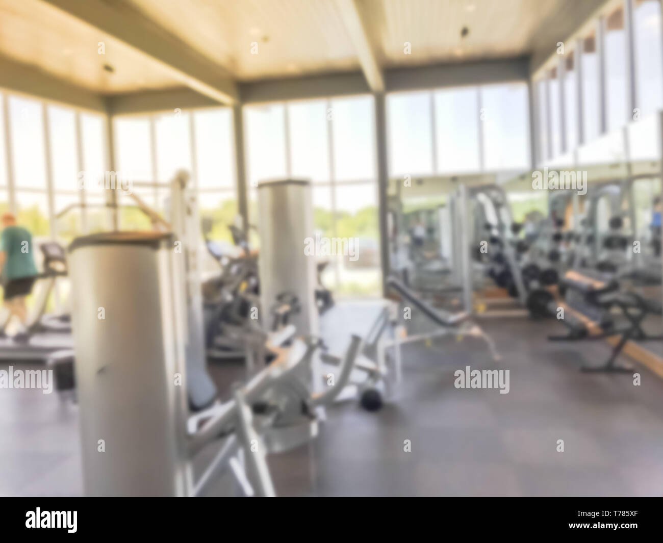 Blurry background open fitness center with people workout at new home ...