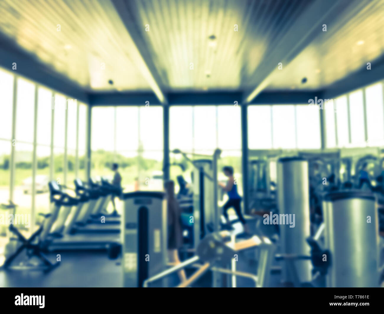Filtered image blurry background open fitness center with people ...