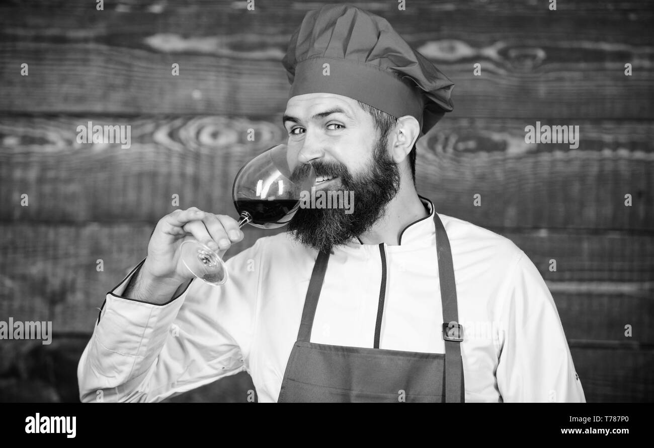 Hipster wear hat and apron enjoy aroma of drink. Man master chef hold ...