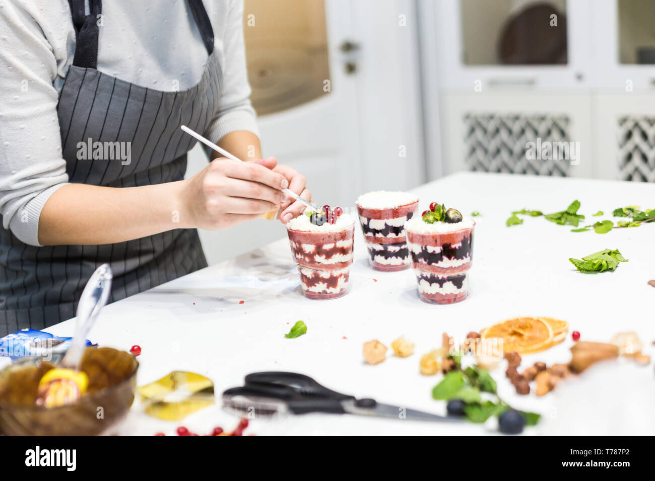 Decoration of the finished dessert. Pastry chef sprinkles confectionery ...