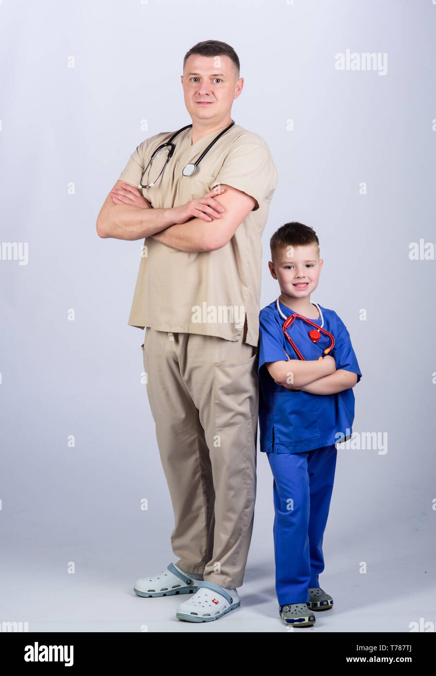 family doctor. happy child with father with stethoscope. medicine and ...