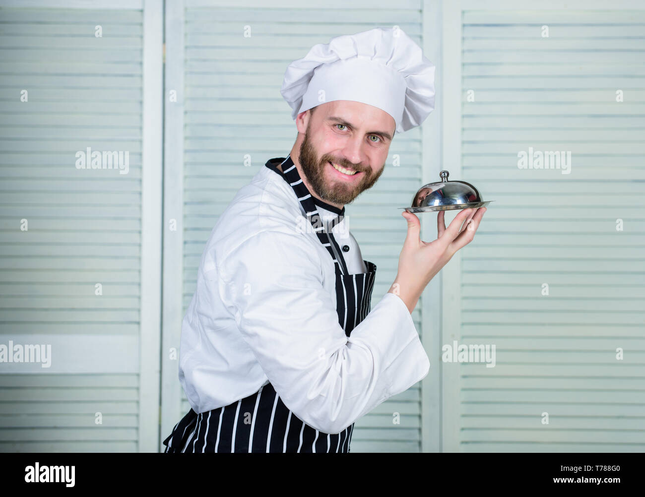 confident man in apron and hat hold tray. cook in restaurant, uniform ...
