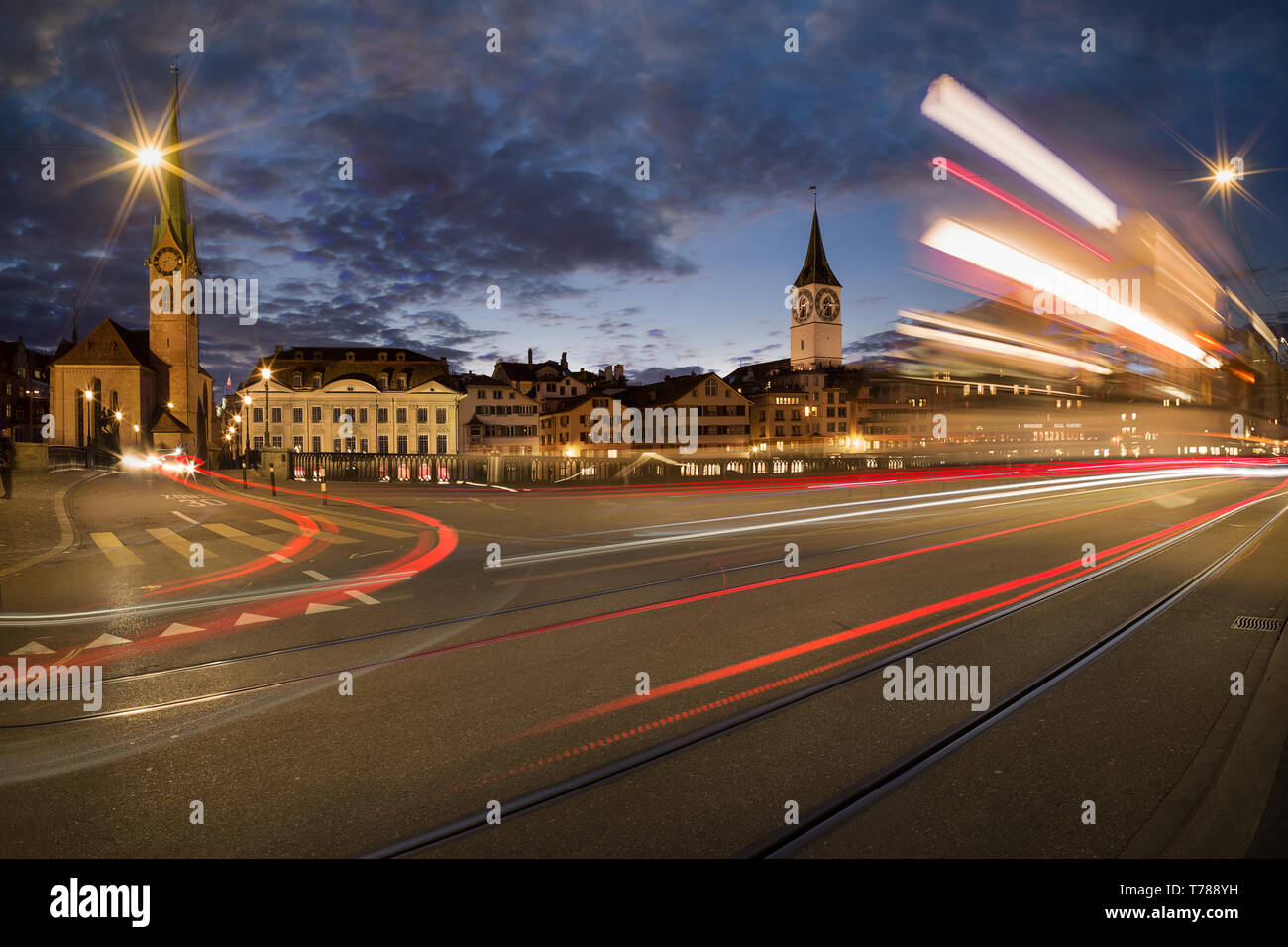 Traffic at night - Zurich skyline with tram and cars going by - long ...
