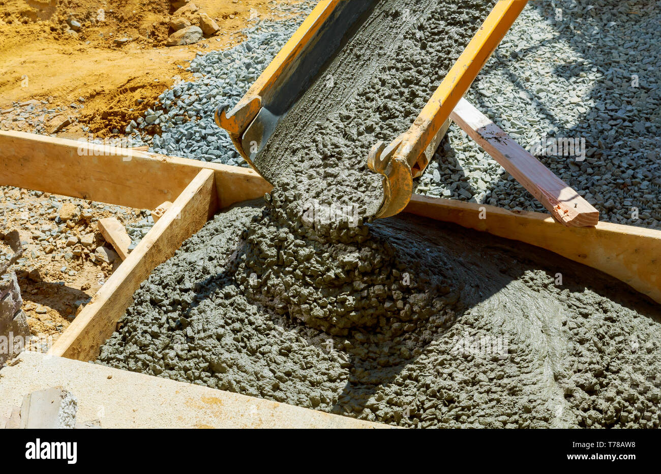 Construction of a concrete walkway around a residential rural house in ...