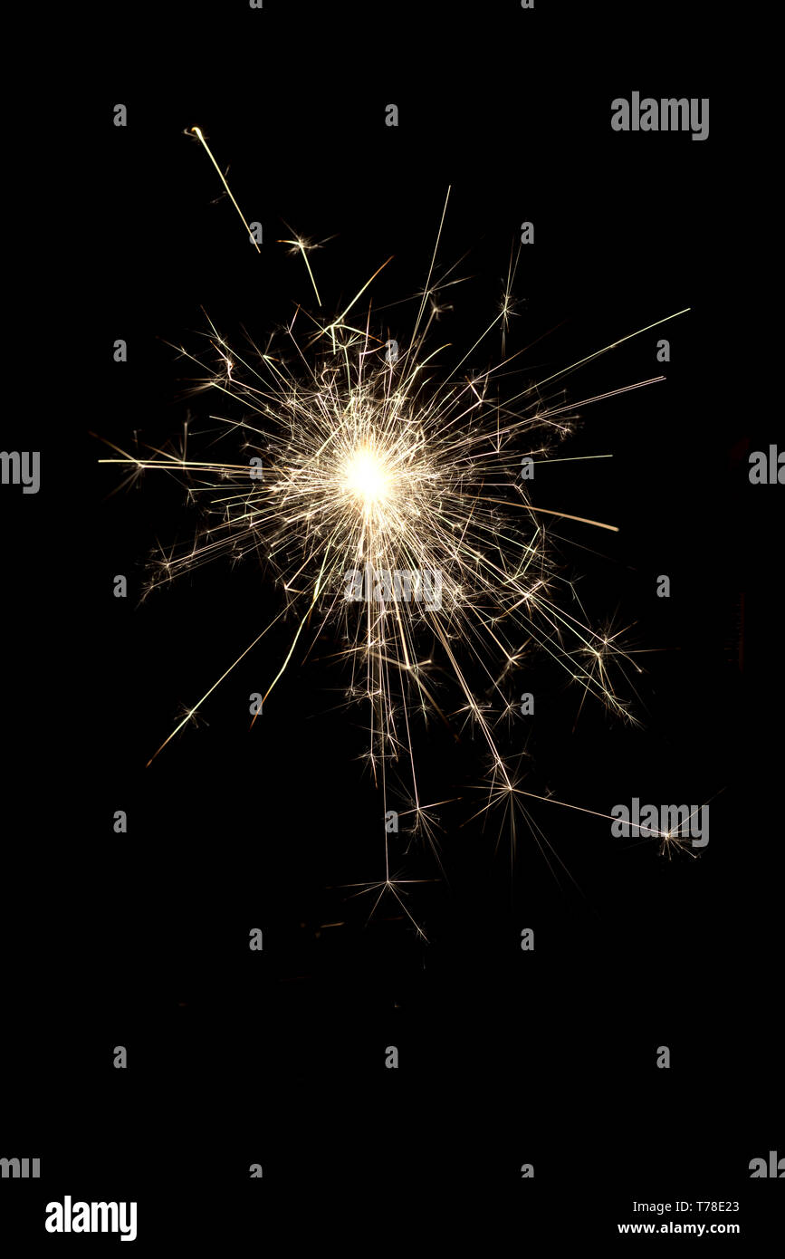 Burning squib on a black background with sparks Stock Photo - Alamy