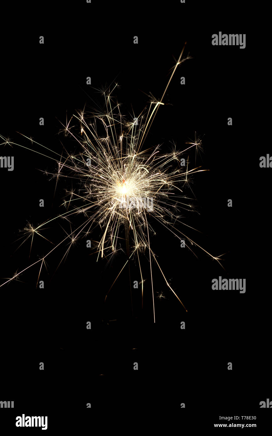 Burning squib on a black background with sparks Stock Photo - Alamy