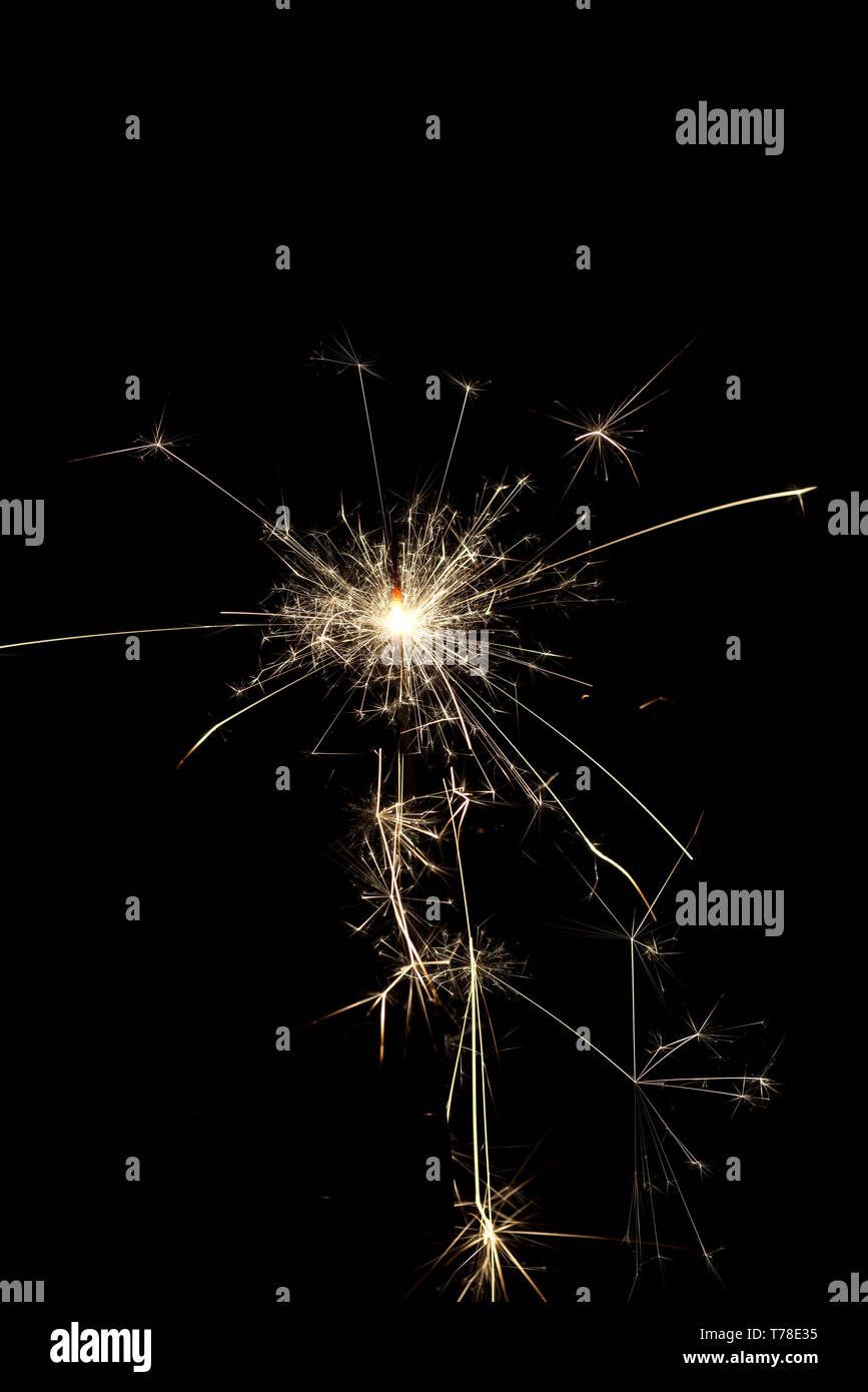 Burning squib on a black background with sparks Stock Photo - Alamy