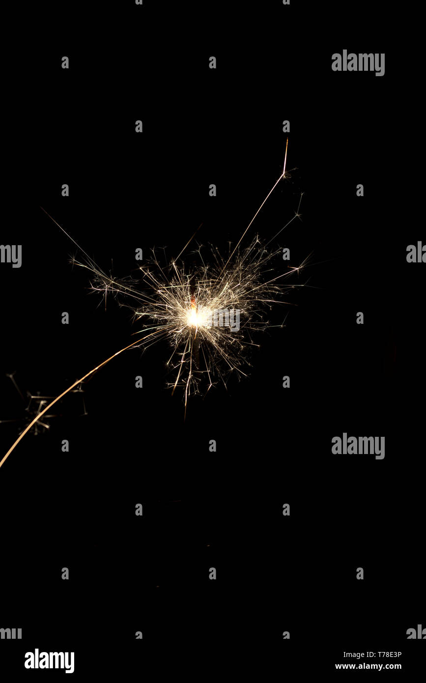 Burning squib on a black background with sparks Stock Photo - Alamy