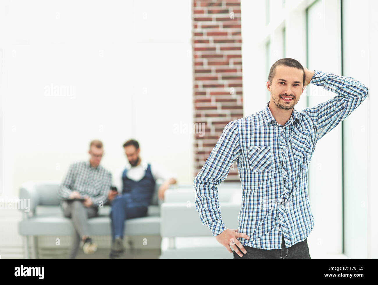 smiling young employee standing in the office .photo with copy space ...