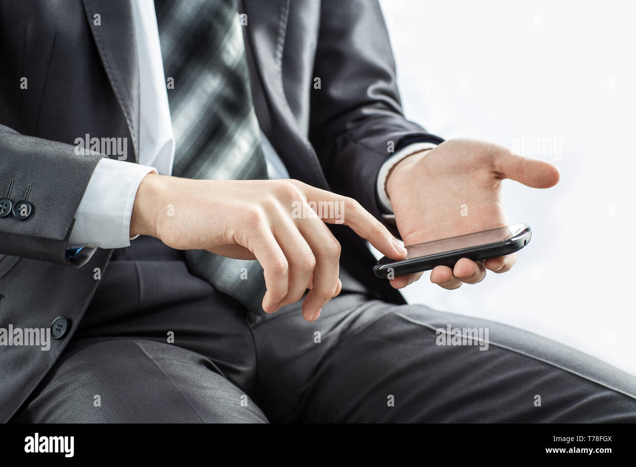 close up. businessman tapping the screen of the mobile phone.photo with ...