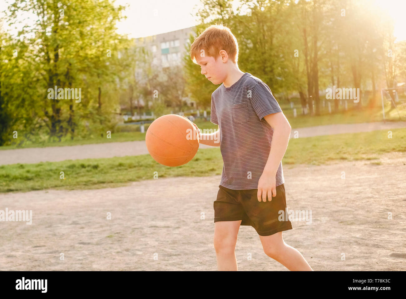 Boy bouncing ball hi-res stock photography and images - Alamy