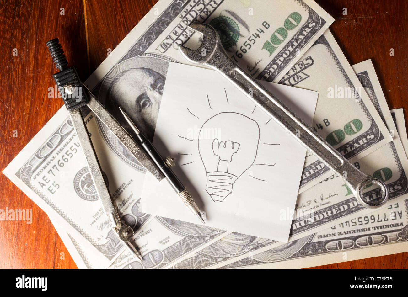 Compass and wrench on money Stock Photo - Alamy