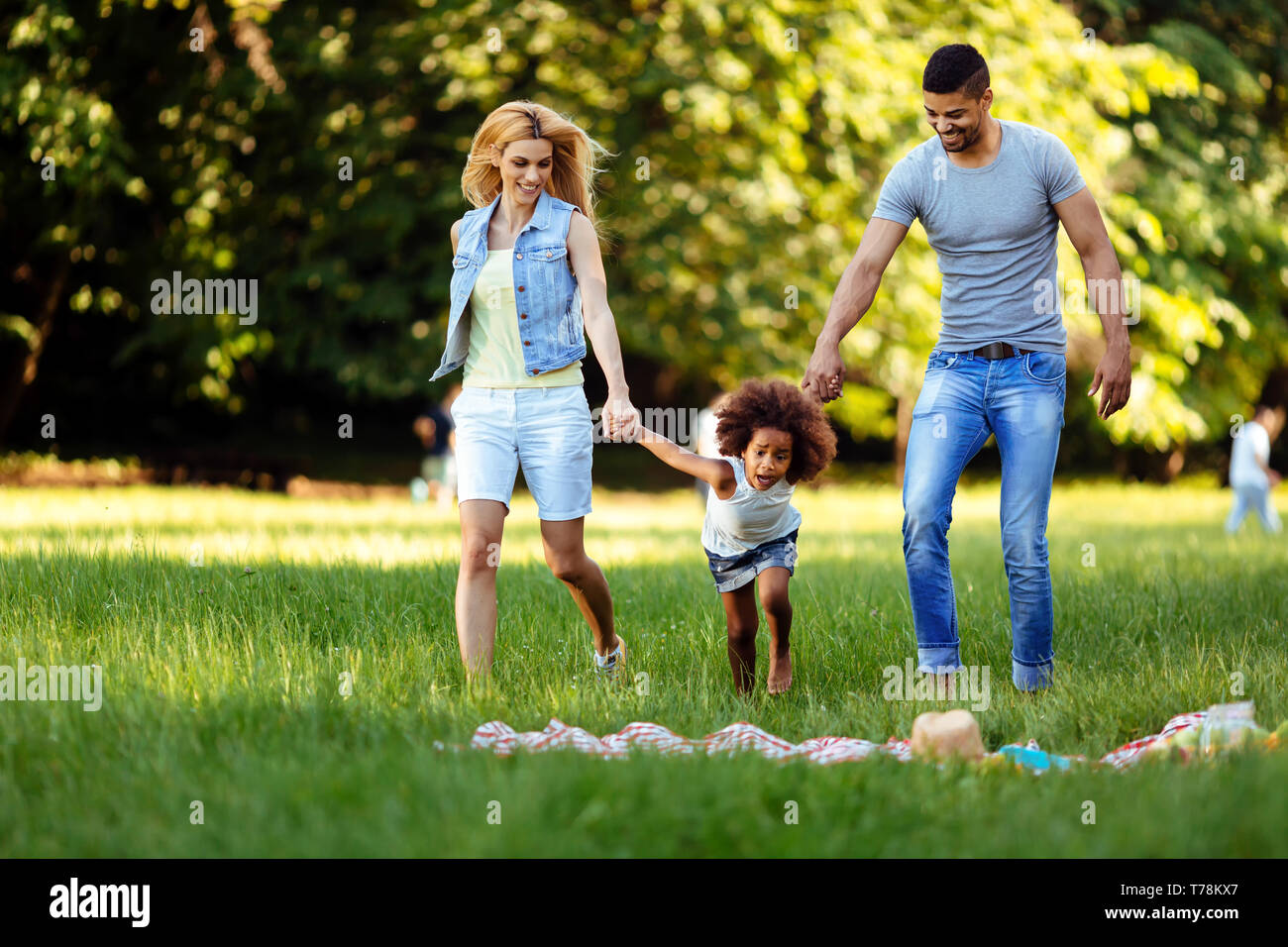 Happy young couple spending time with their daughter Stock Photo - Alamy