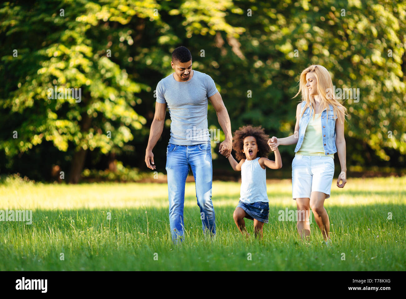 Happy young couple spending time with their daughter Stock Photo - Alamy
