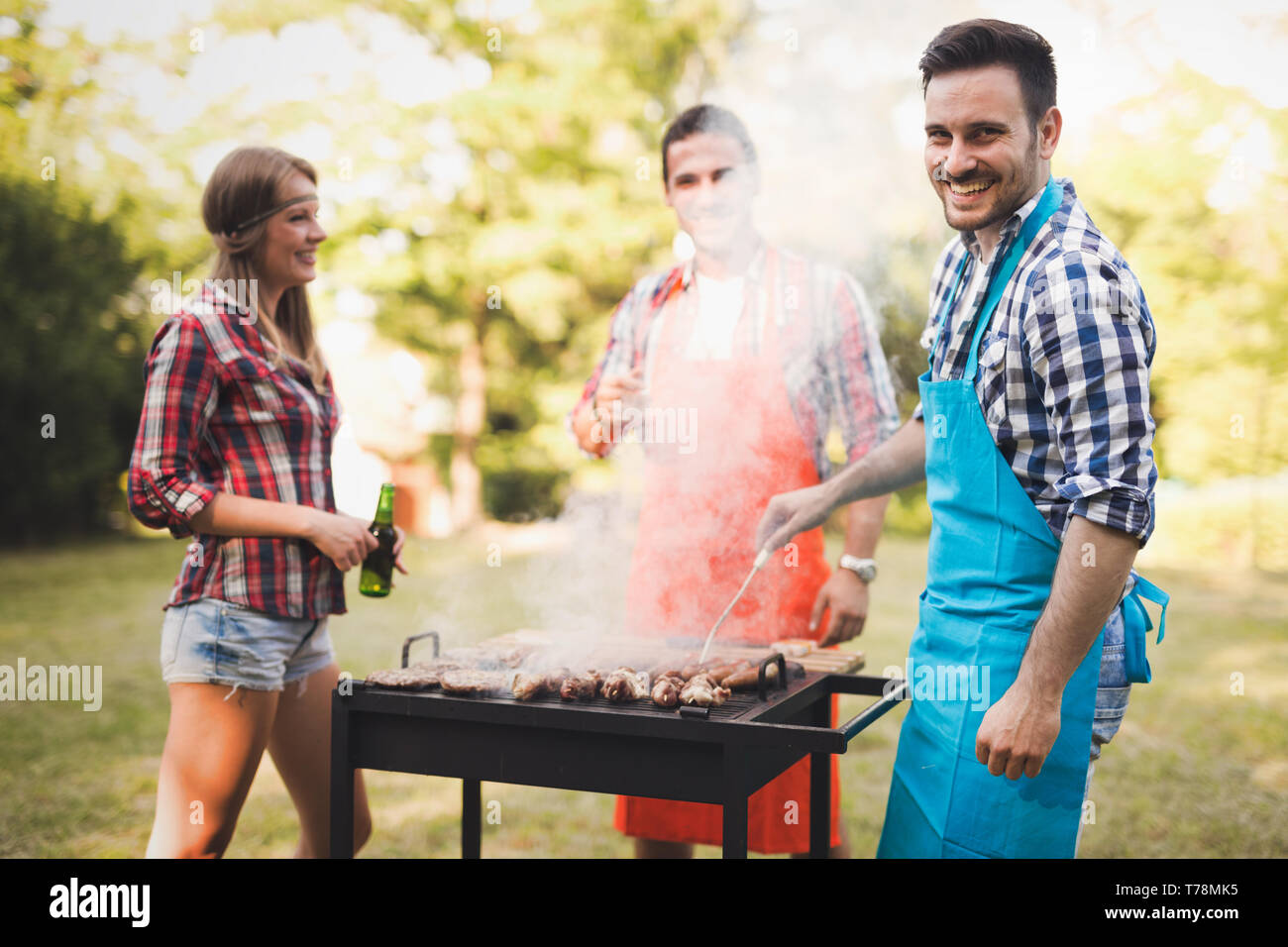 Happy people having camping and having bbq party Stock Photo - Alamy