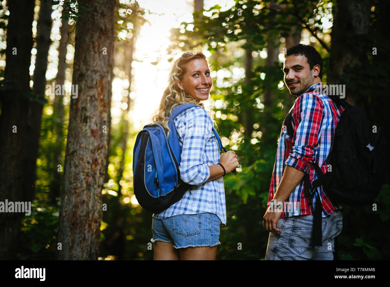 Happy couple trekking and hiking in forest Stock Photo - Alamy