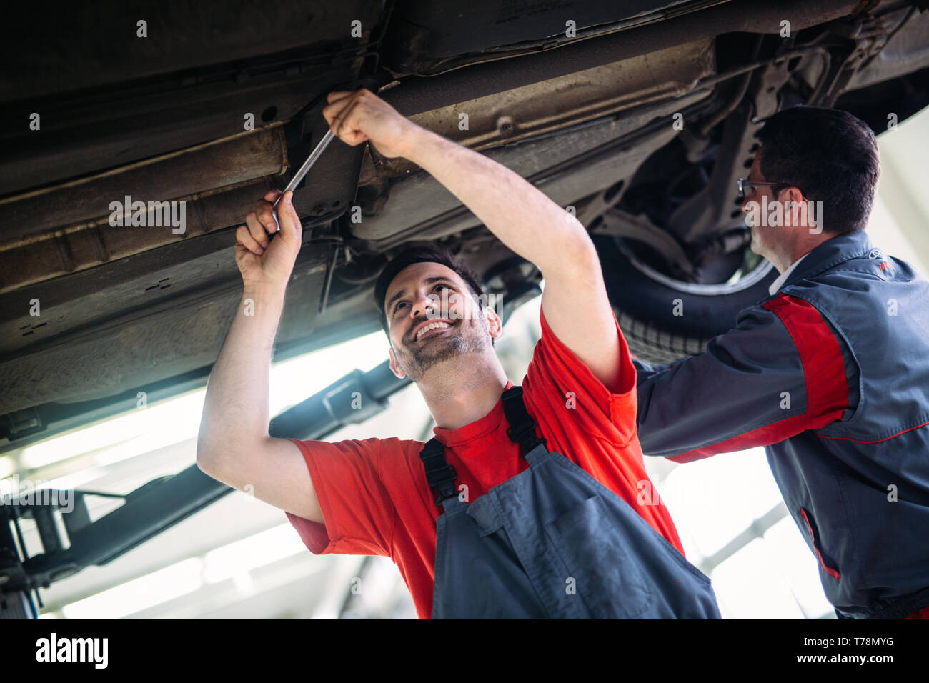 Auto mechanic working in garage. Repair service Stock Photo - Alamy