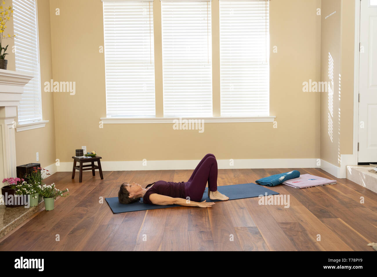 Yoga pose on back arms at sides Stock Photo - Alamy