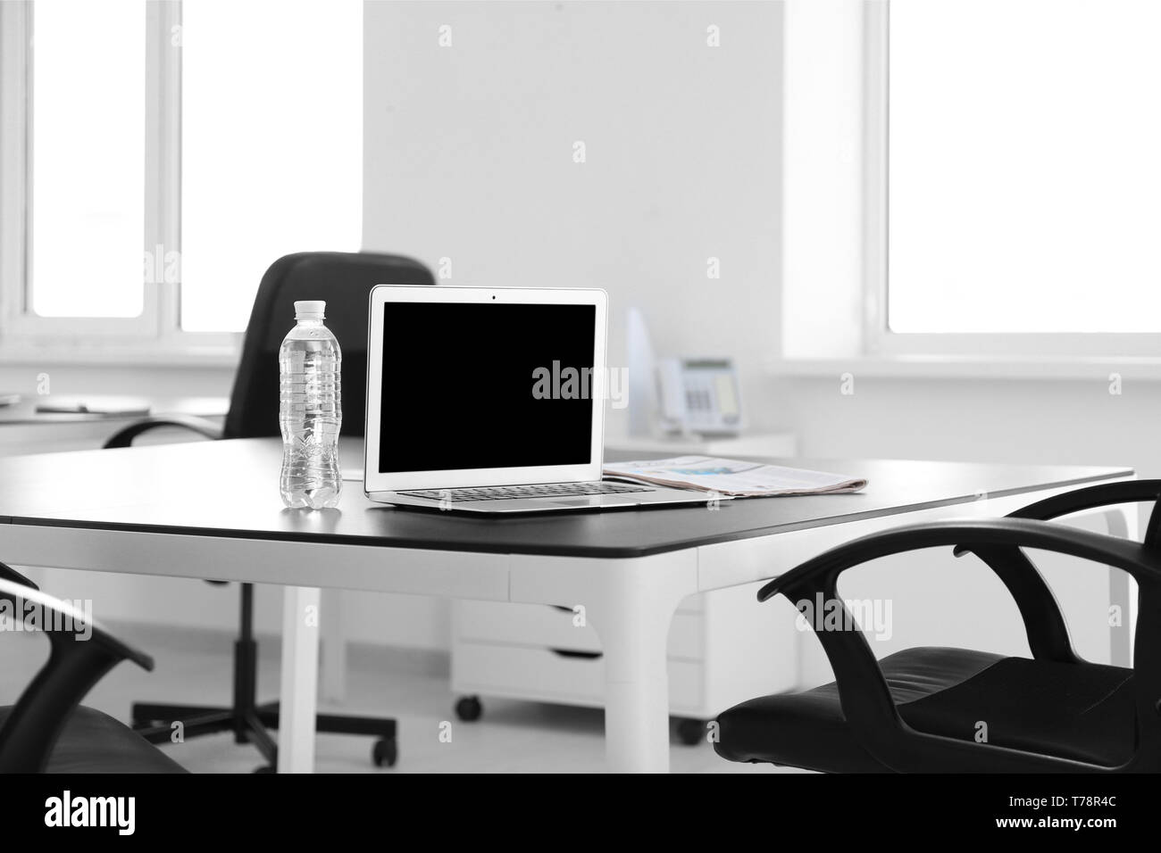 Stylish workplace with laptop on table in office Stock Photo - Alamy