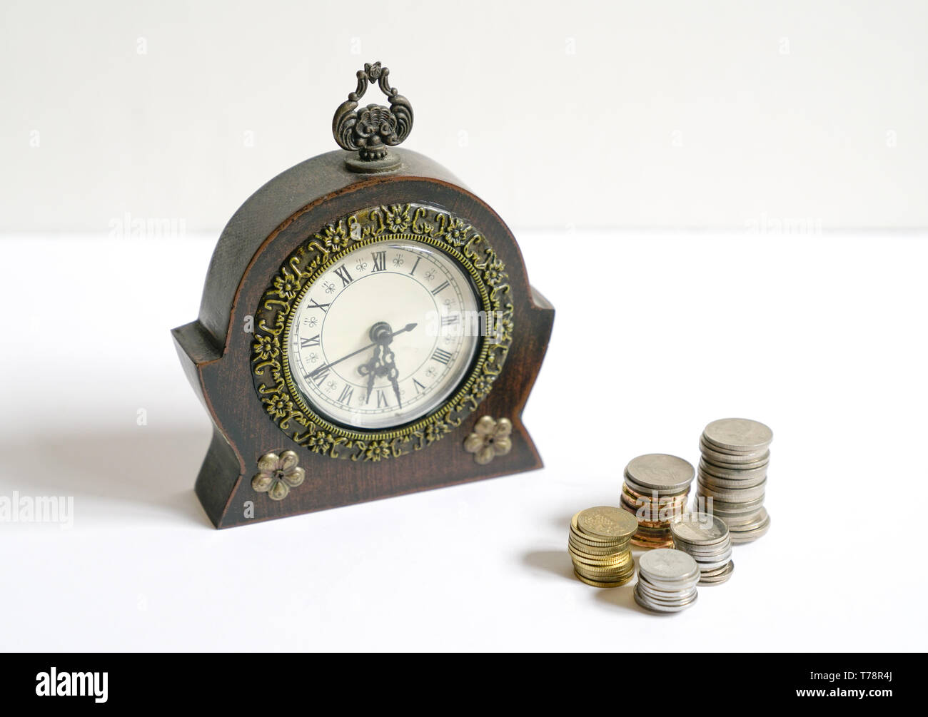 Clock and stacked coins. Time is money or savings concept Stock Photo ...