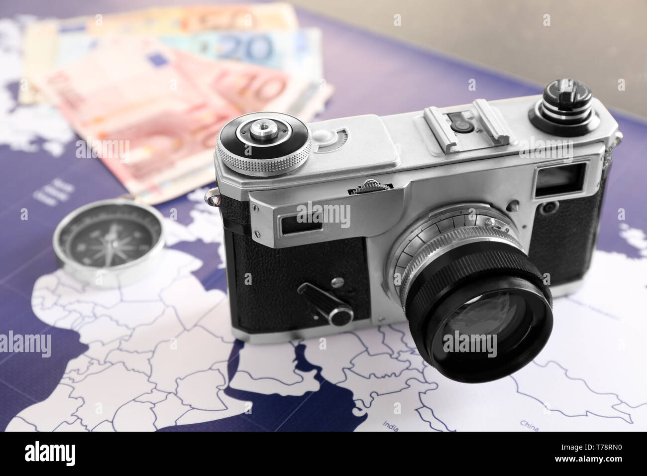 Modern camera on world map. Travel concept Stock Photo - Alamy