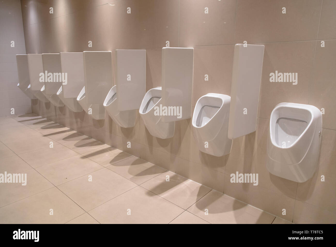 Row of modern Urinals in new bathroom of Theater Stock Photo - Alamy