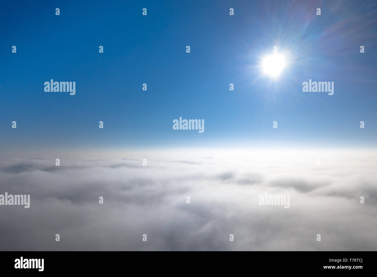 Aerial view of mist layer from above looking like sun shining above ...