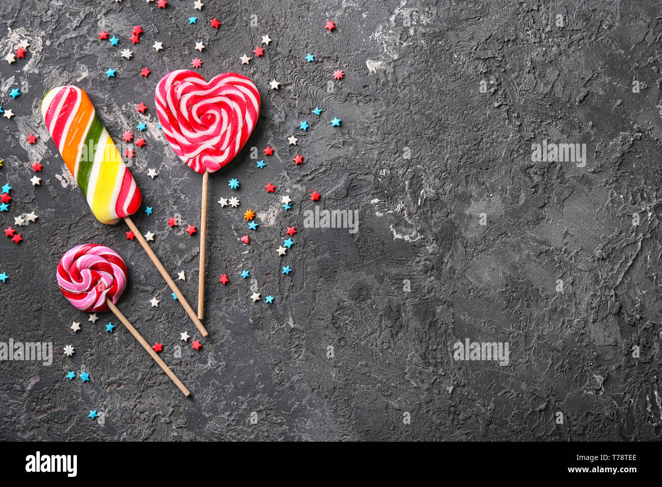 Different colorful candies on dark textured background Stock Photo - Alamy