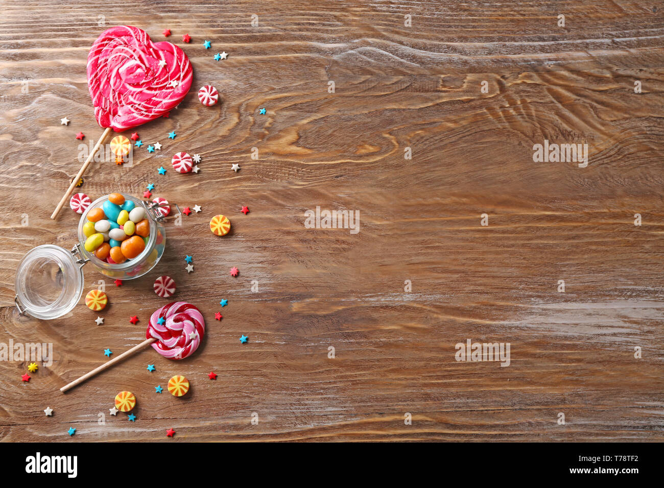 Colorful candies on wooden background Stock Photo - Alamy