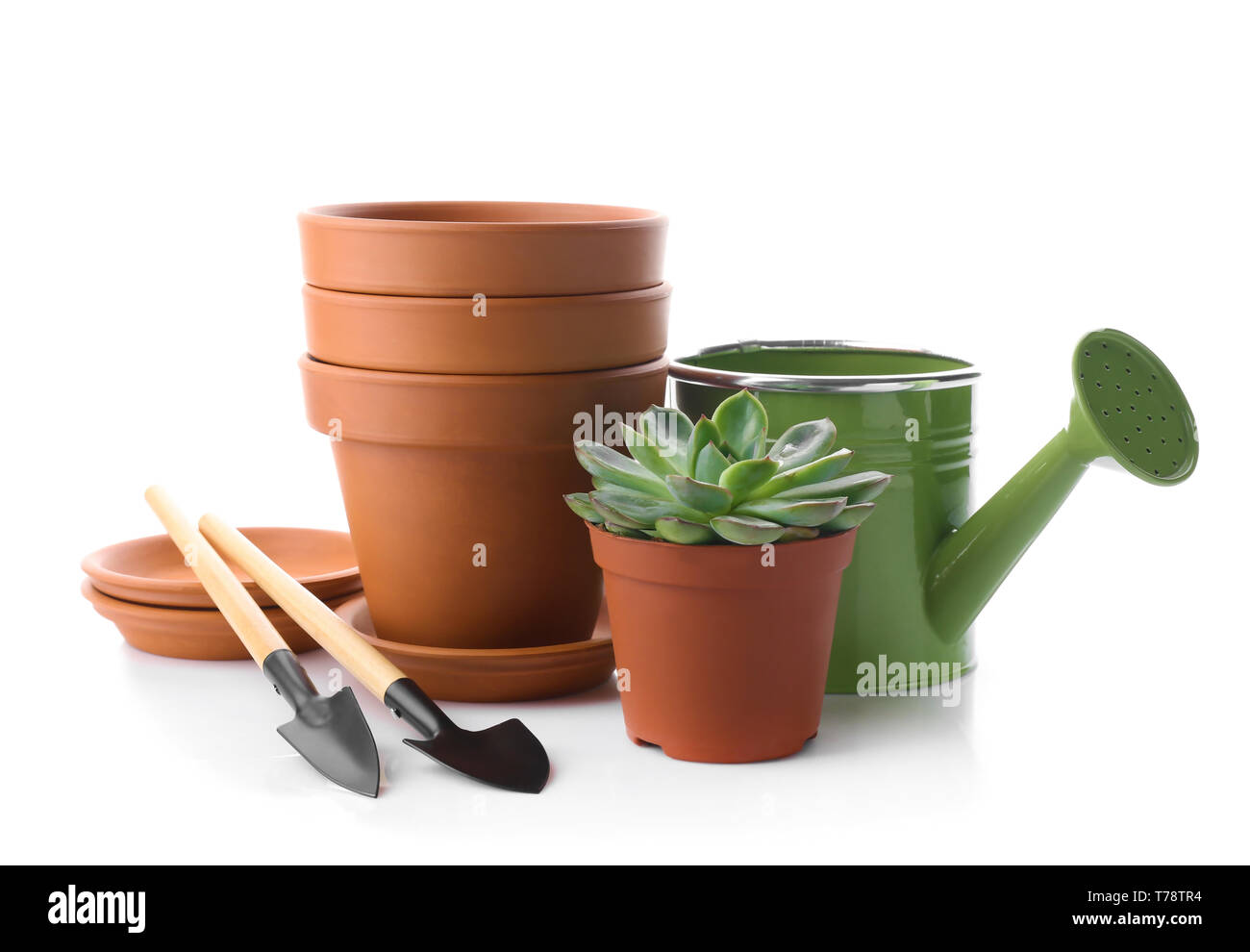 Empty pots with gardening tools on white background Stock Photo - Alamy