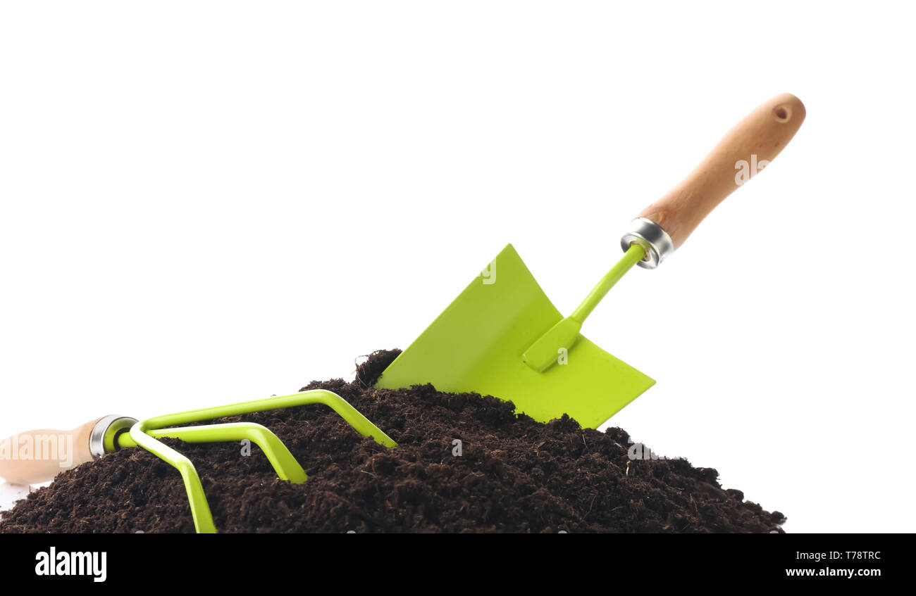 Gardening tools with soil on white background Stock Photo - Alamy