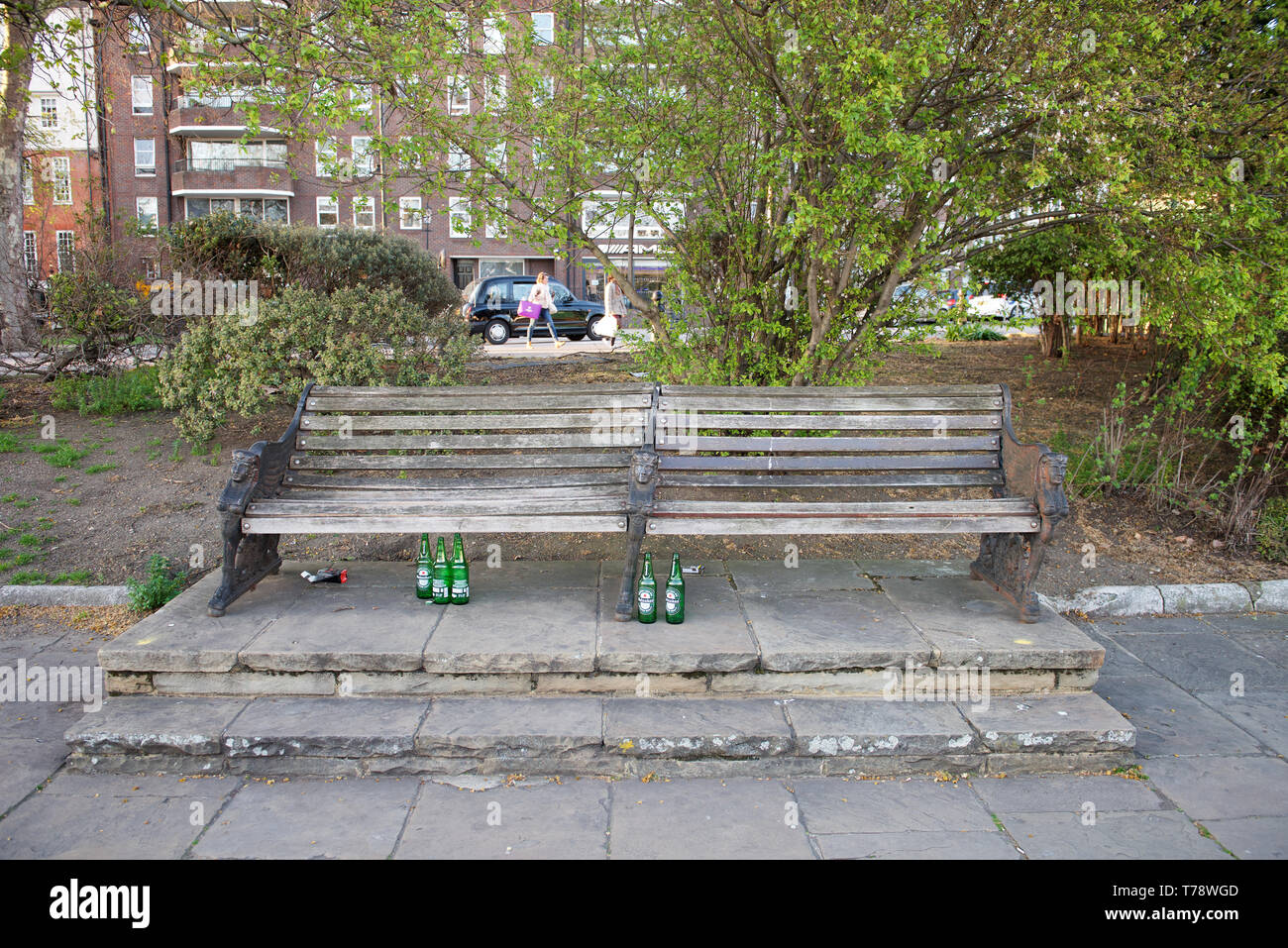 Bench with empty beer bottles and cigarette pack Stock Photo - Alamy