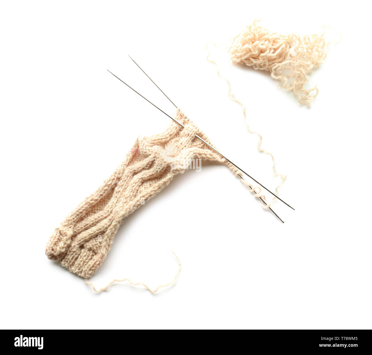 Knitting thread with unfinished clothes on white background Stock Photo ...