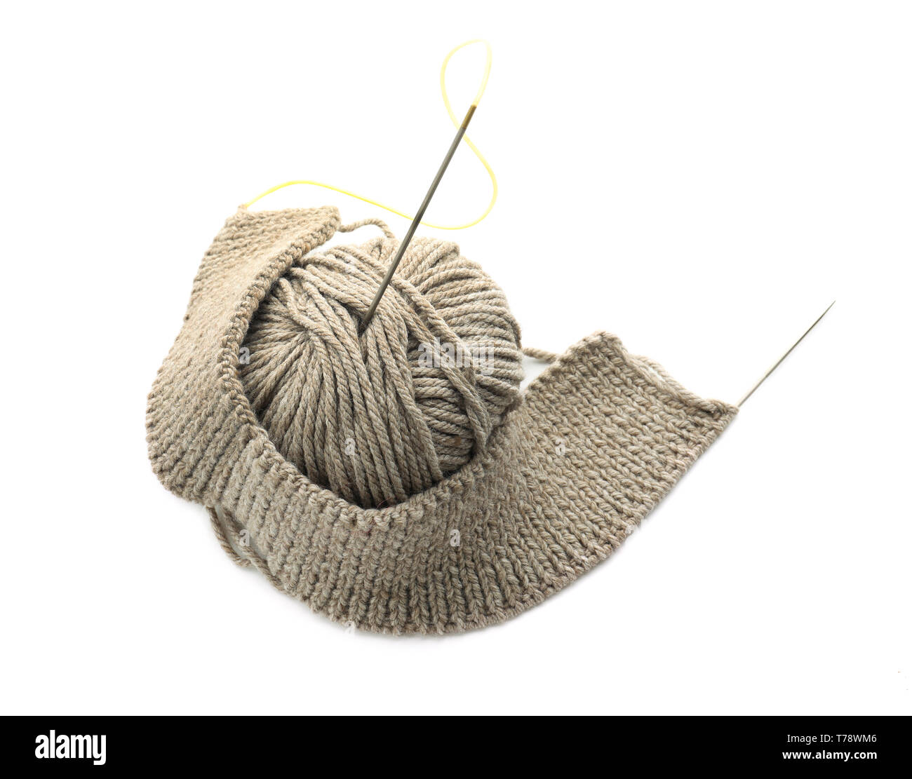 Knitting thread with unfinished clothes on white background Stock Photo ...