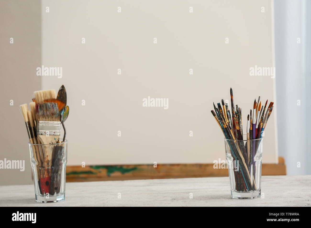 Set of tools with easel of professional artist on table in workshop ...