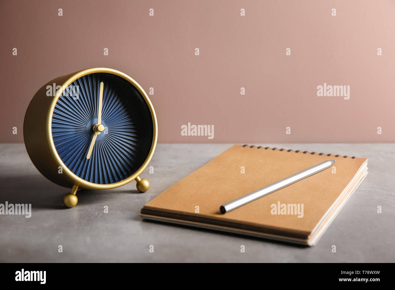 Alarm clock with notebook on table. Time management concept Stock Photo ...