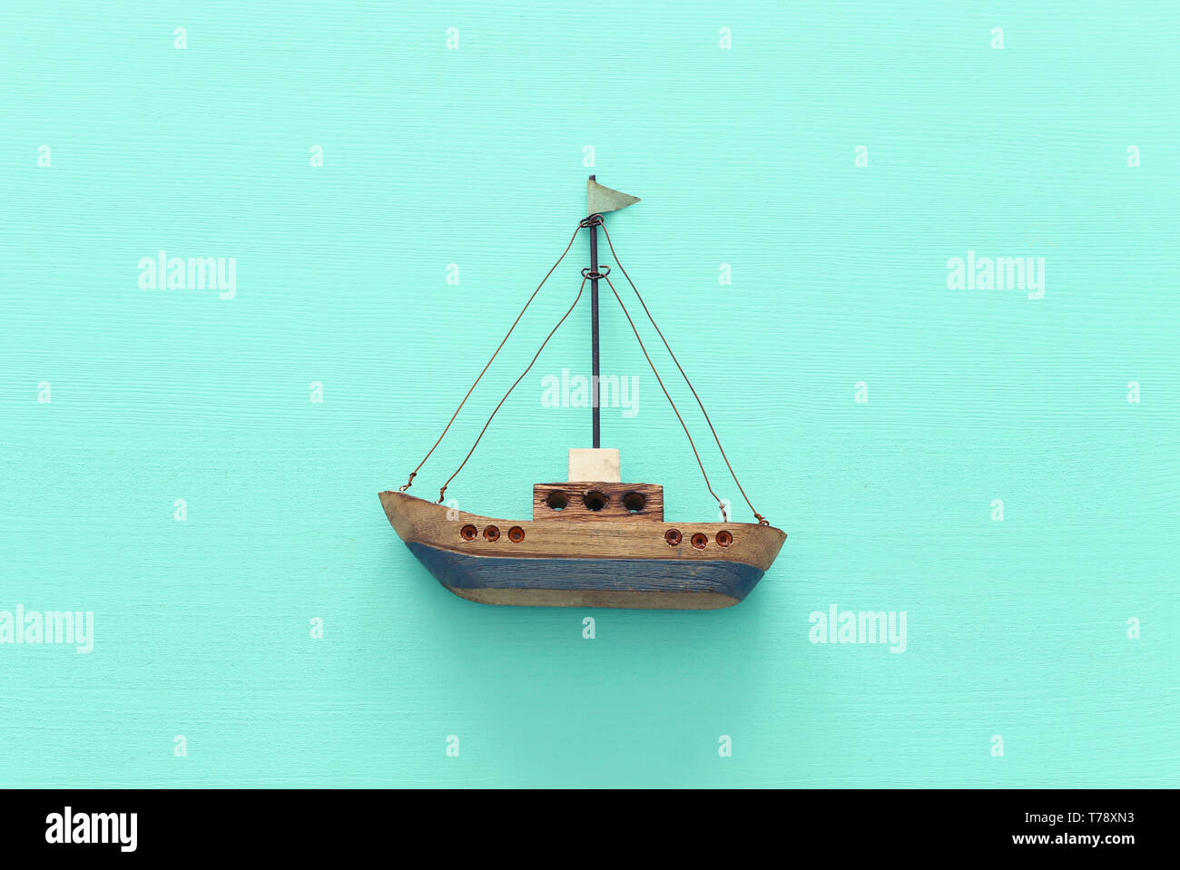 wooden vintage boat over blue background Stock Photo - Alamy
