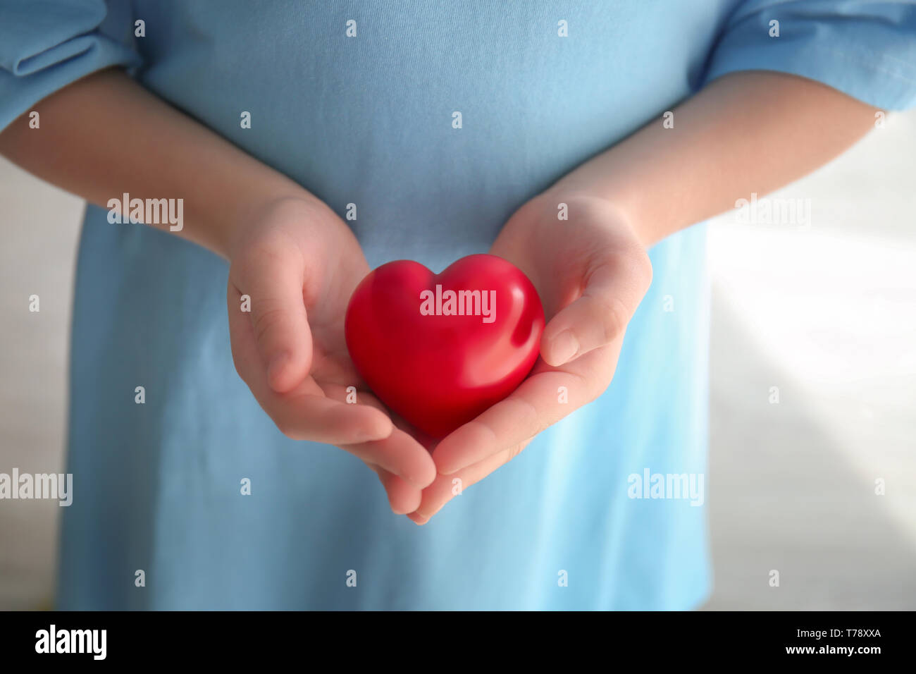 Child holding red heart, closeup. Health care concept Stock Photo - Alamy