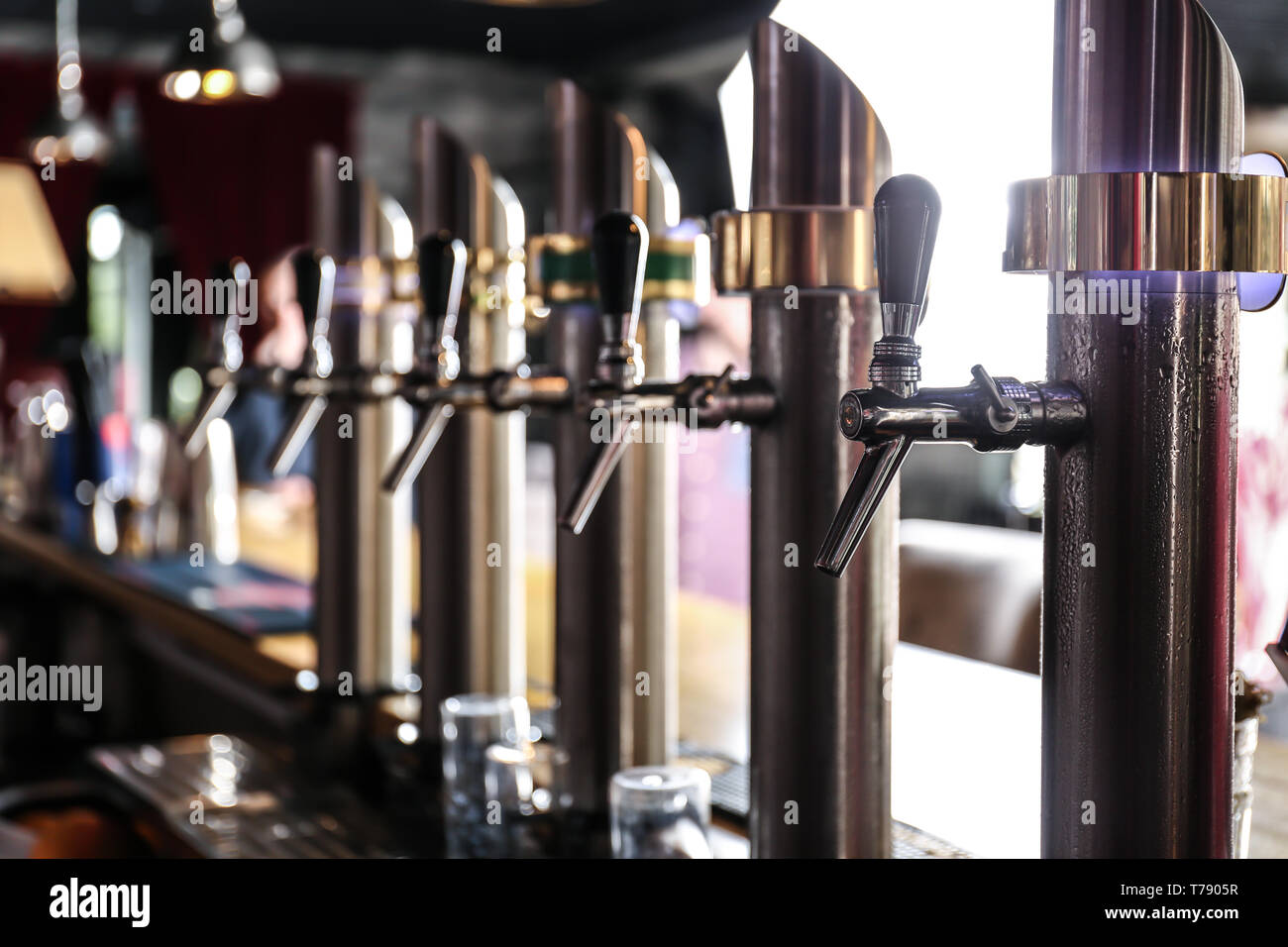 Draft beer taps in modern bar Stock Photo - Alamy