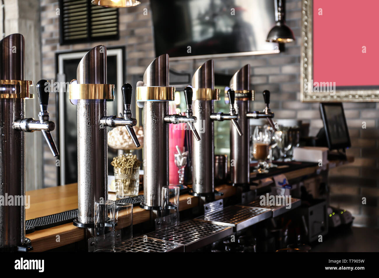 Draft beer taps in modern bar Stock Photo - Alamy