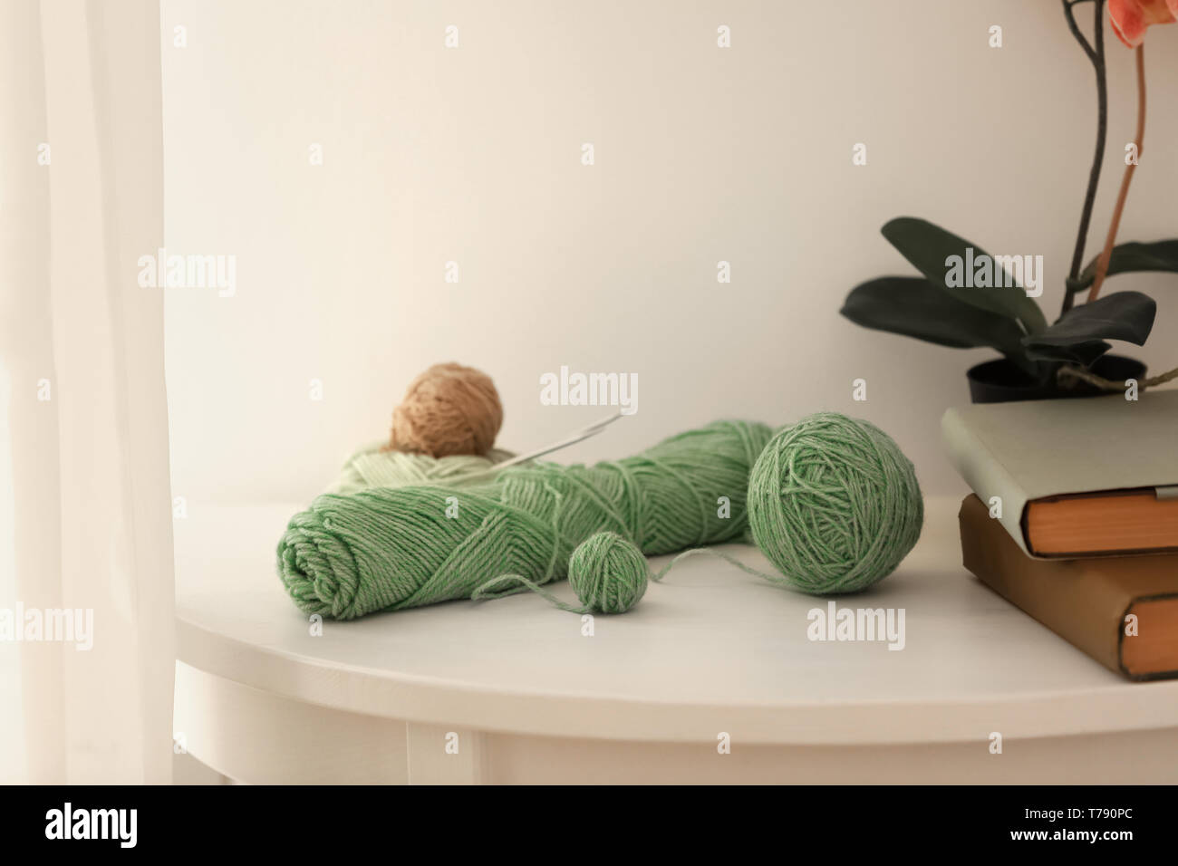 Set of knitting threads on table Stock Photo - Alamy