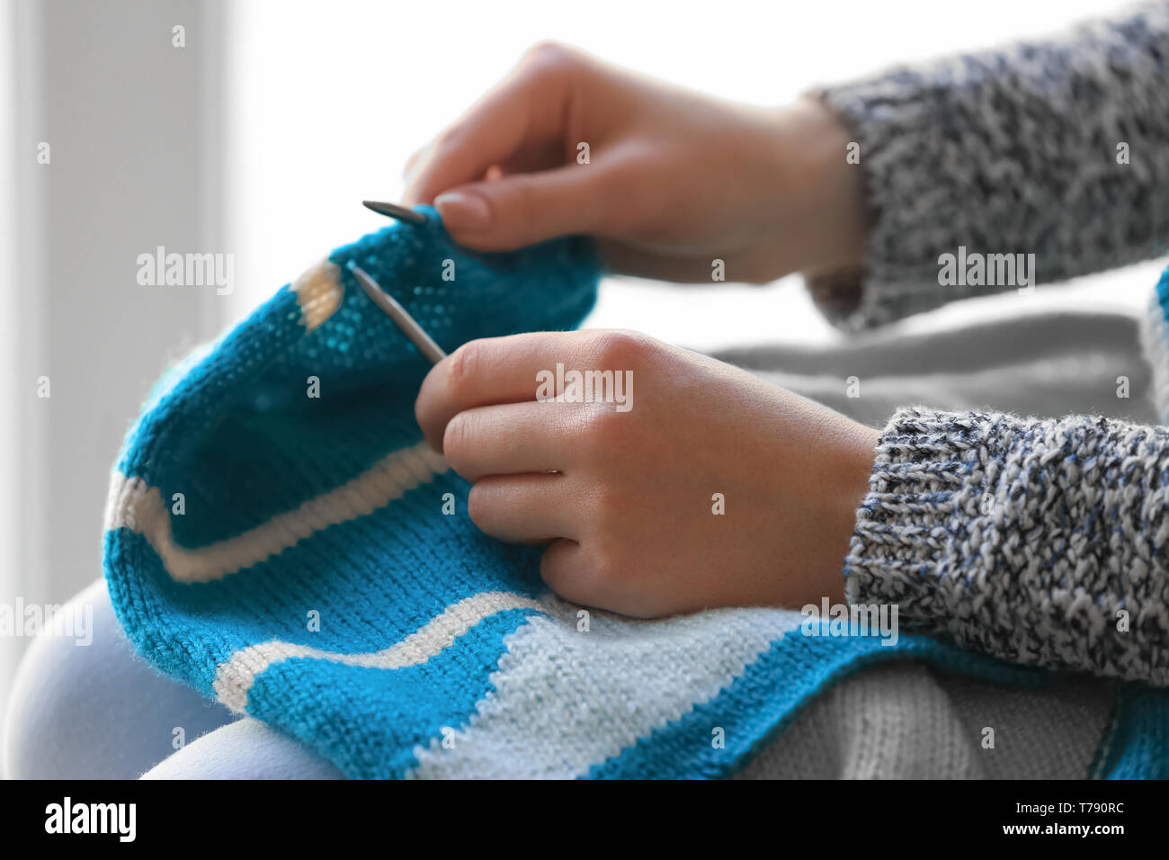 Young woman knitting warm sweater, closeup Stock Photo - Alamy
