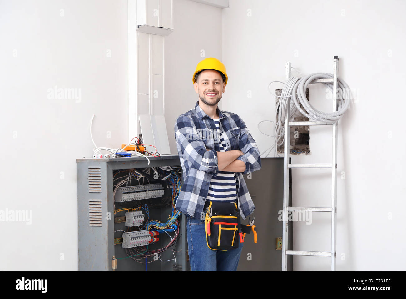 Electrician repairing distribution board indoors Stock Photo - Alamy