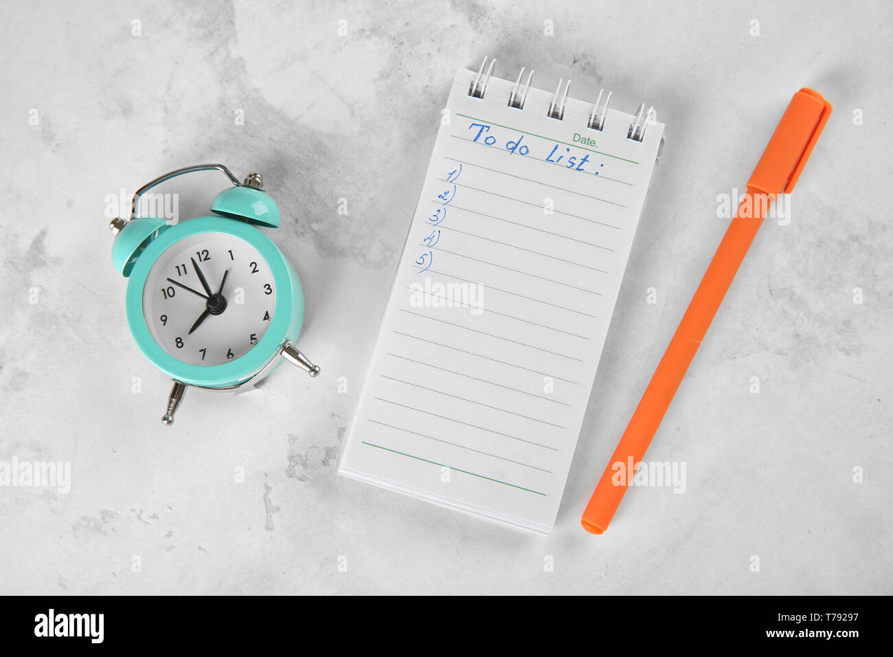 Alarm clock with pen and to-do list on light background. Time ...