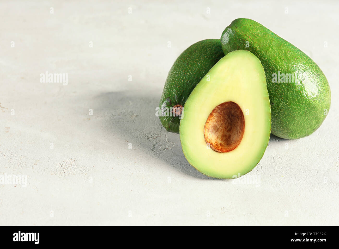 Ripe avocados on light background Stock Photo - Alamy